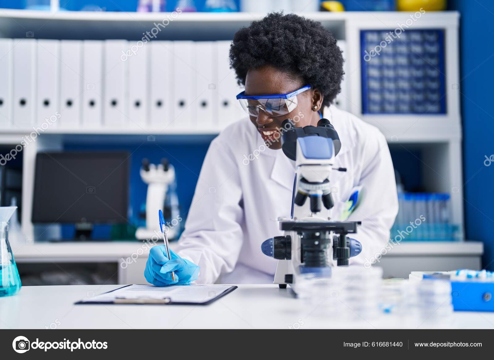 Young African American Woman Scientist Writing Document Using Microscope Laboratory — Stock ...