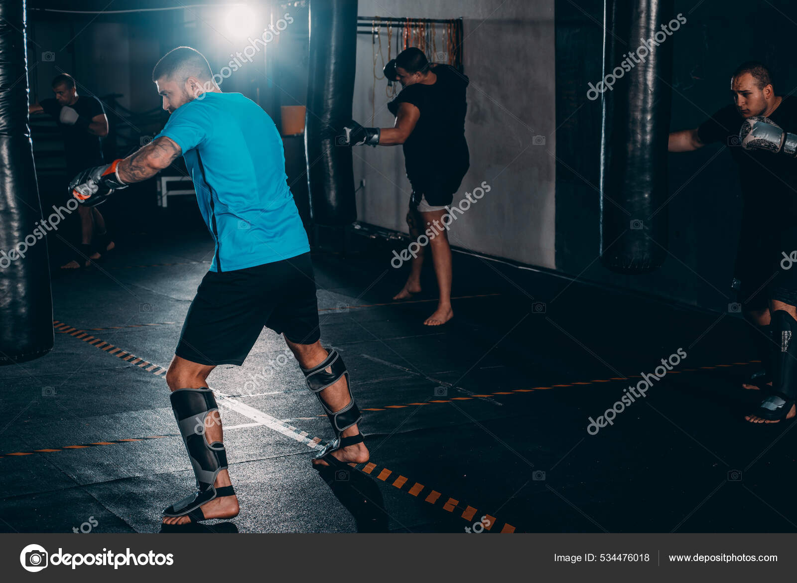 Handsome Muscular Man Boxing Gloves Practicing Punching Bag While ...