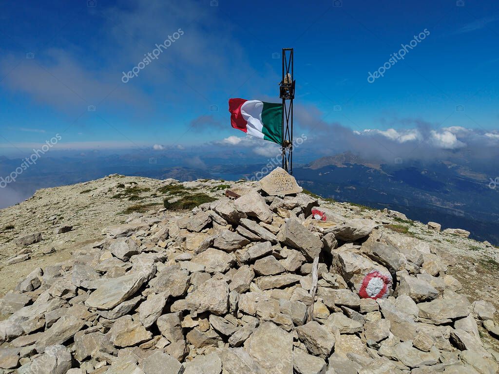 View of the italian flag on the peak of Monte Corvo in Abruzzo 2024