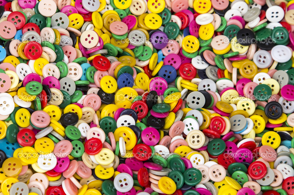 Background or texture of a pile of buttons of many colors and si ...