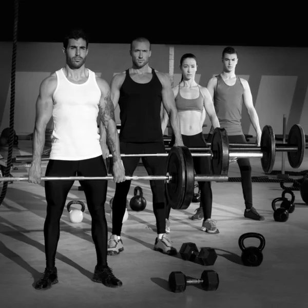 Gym group with weight lifting bar crossfit workout - Stock Image ...