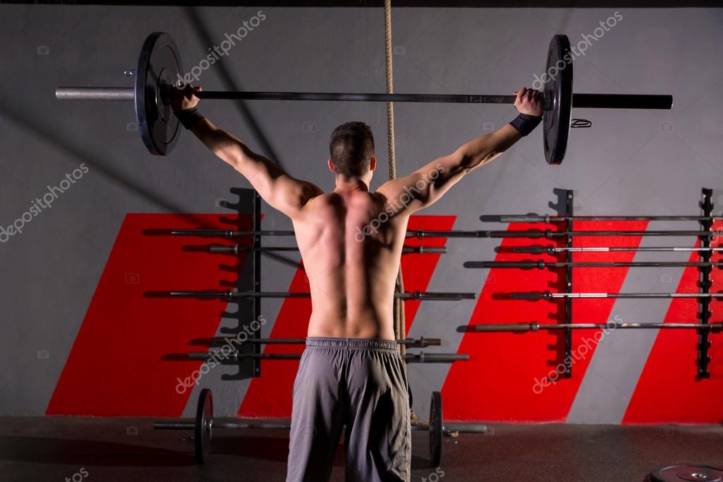 Barbell weight lifting man rear view workout gym — Stock Photo © lunamarina #44277447