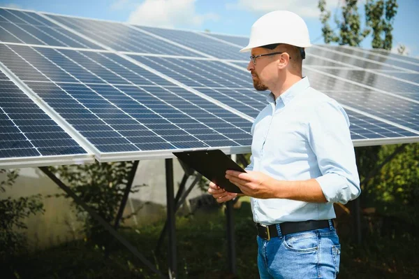 Engineer at solar power station with solar panel. Practical lessons on ...