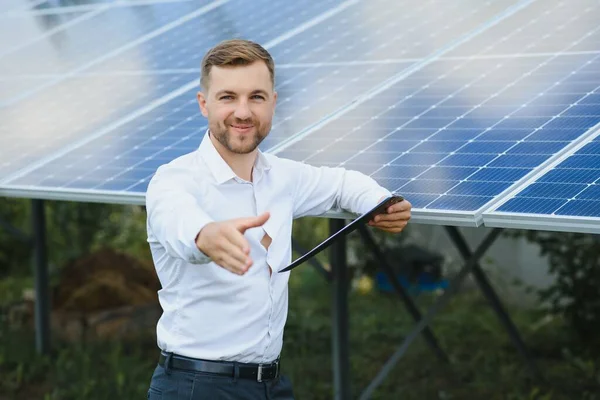 Engineer at solar power station with solar panel. Practical lessons on ...