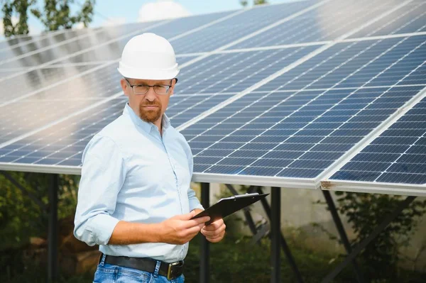 Solar energy. Young business man near the solar panels to power plants ...