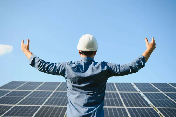 Solar power plant. Engineer on a background of photovoltaic panels ...