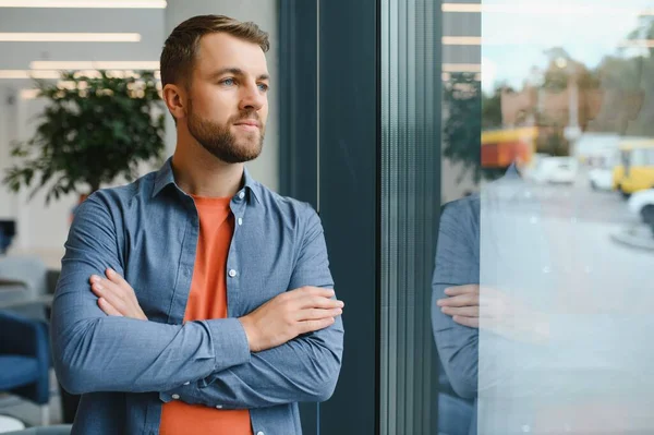 Portrait of young man near in window. - Stock Image - Everypixel