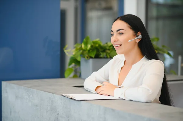 Portrait of beautiful receptionist near counter in hotel. - Stock Image ...