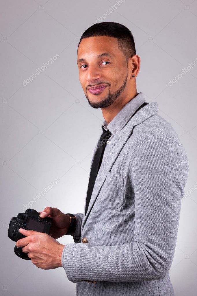 African american photographer holding a dslr camera - Black peop Stock ...