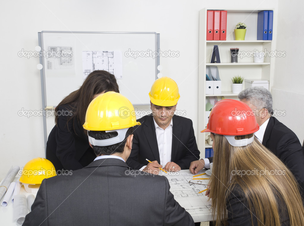 Architects sitting at table and looking at a project — Stock Photo ...