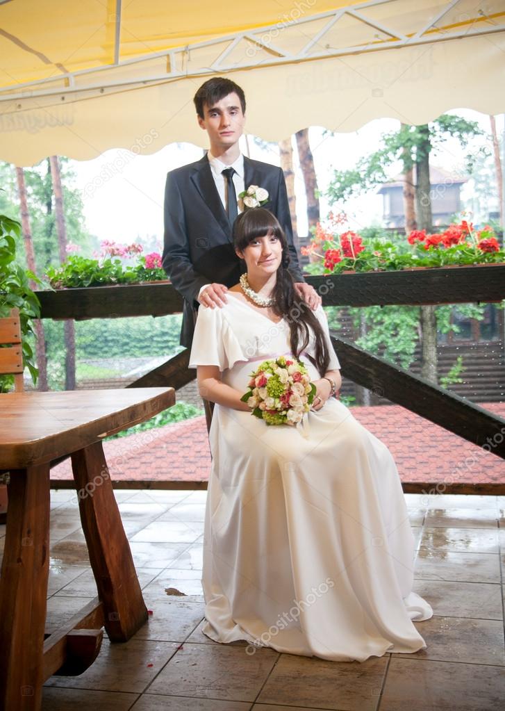 Groom standing behind sitting bride — Stock Photo © Kryzhov #33374407