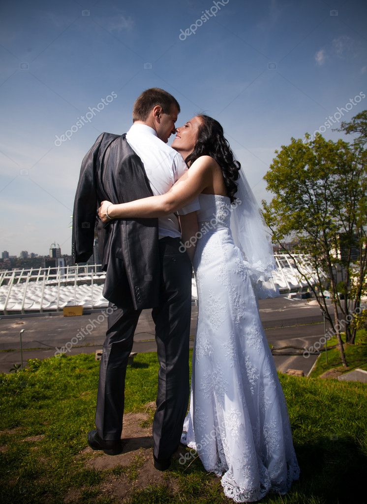 Beautiful newly married couple hugging on top of hill Stock Photo by ...