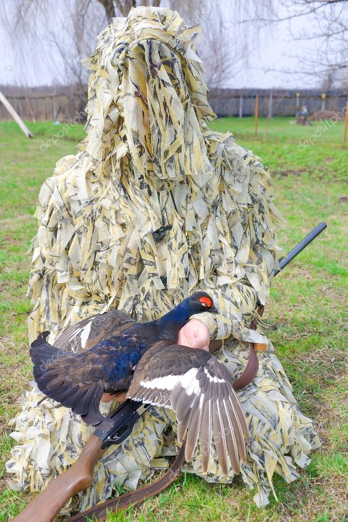 Hunter holding a trophy. vertical photo. Stock Photo by ©evgenyiL 25203895