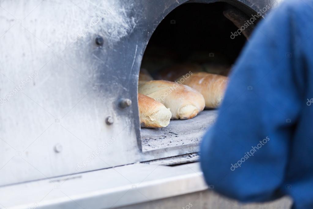 Traditional baking bread in a wood oven — Stock Photo © Chretien #29676727