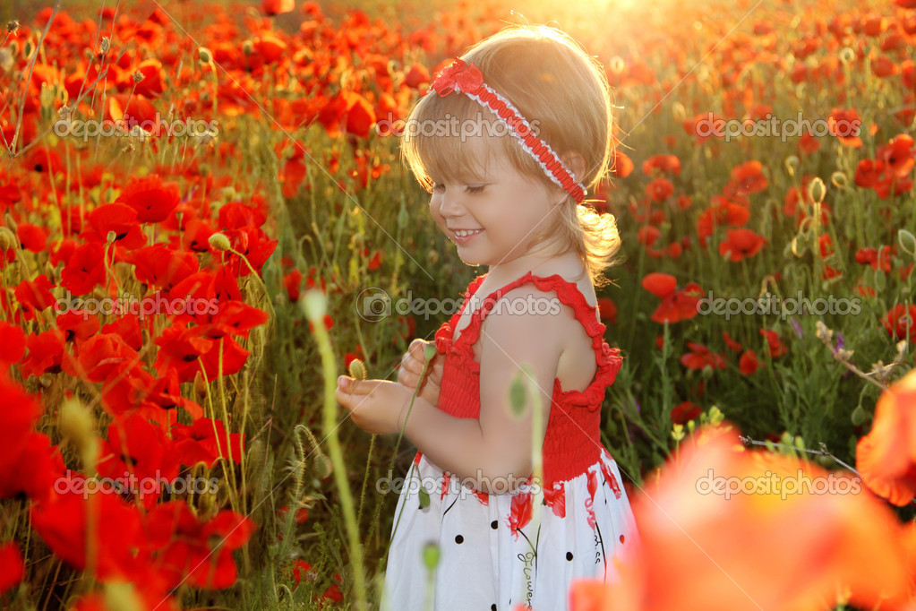 Happy Smiling little girl in red poppies filed, sunset. Outdoors Stock ...