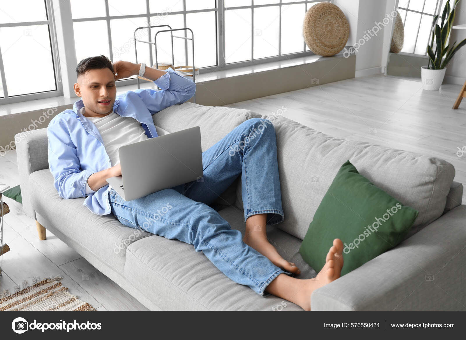 Young Barefoot Man Using Laptop Sofa Home — Stock Photo © serezniy ...
