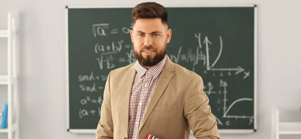 Handsome Math Teacher Reading Book Classroom Stock Photo by ©serezniy ...