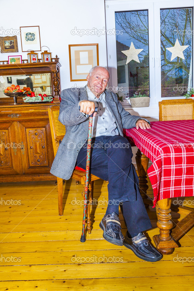 Old Grandfather sitting with his walking stick at the table — Stock ...
