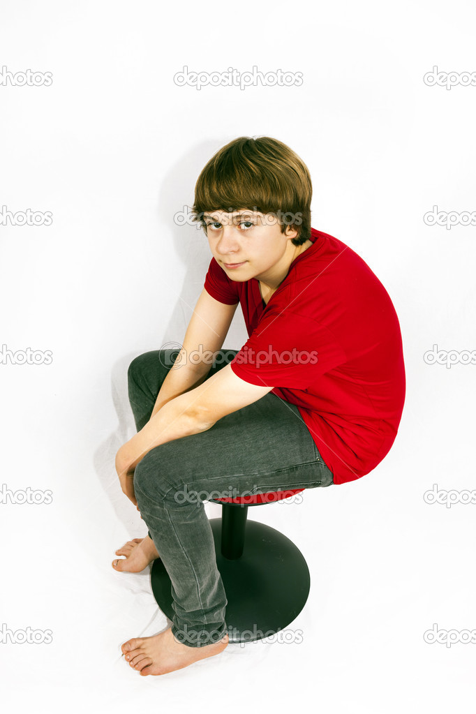 Teenage boy sitting on a chair — Stock Photo © Hackman #41420215