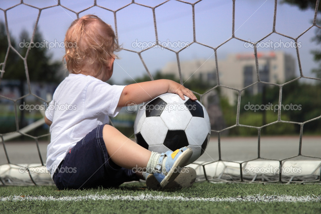 Boy with ball in gate Stock Photo by ©chepko 17136987