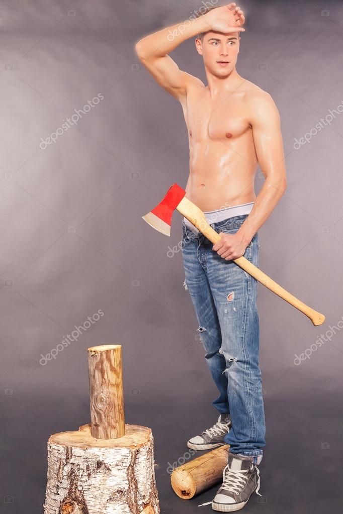 Muscular young man chopping logs Stock Photo by ©STphotography 43311477