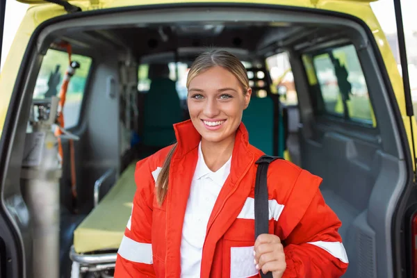 Ambulance staff member emerges from the back of an ambulance with her ...