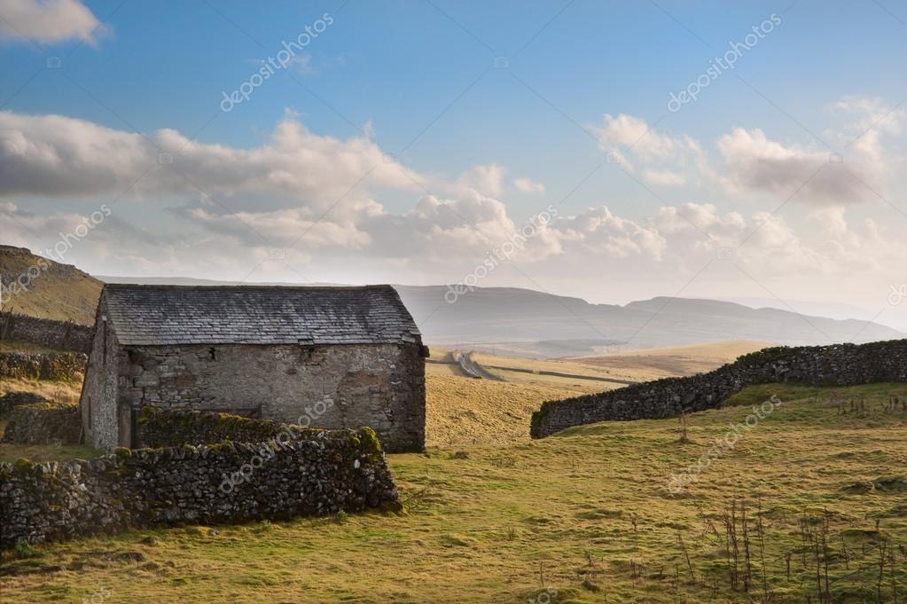 Stone barn and rock walls in Autumn sunset landscape Stock Photo by ...