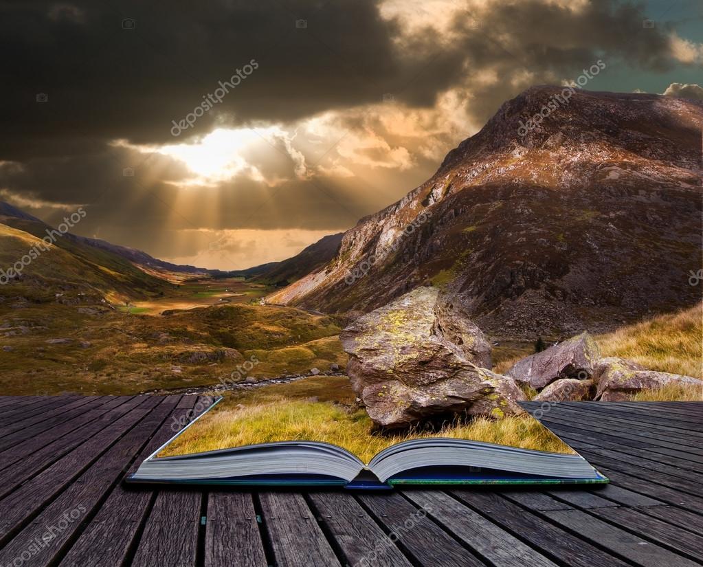 Moody dramatic mountain sunset landscape in pages of book — Stock Photo ...