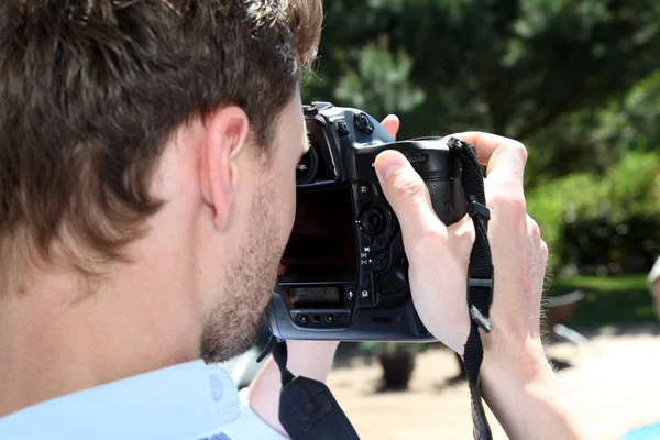 Closeup on man using photo camera - Stock Image - Everypixel