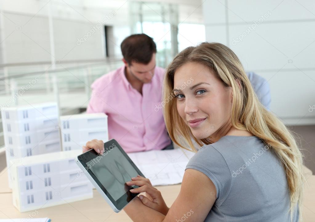 Beautiful woman in office using electronic tablet Stock Photo by ...