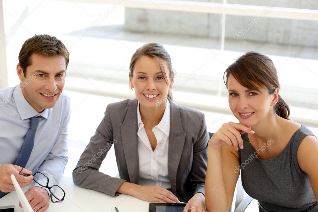 Business presentation around table Stock Photo by ©Goodluz 13960329