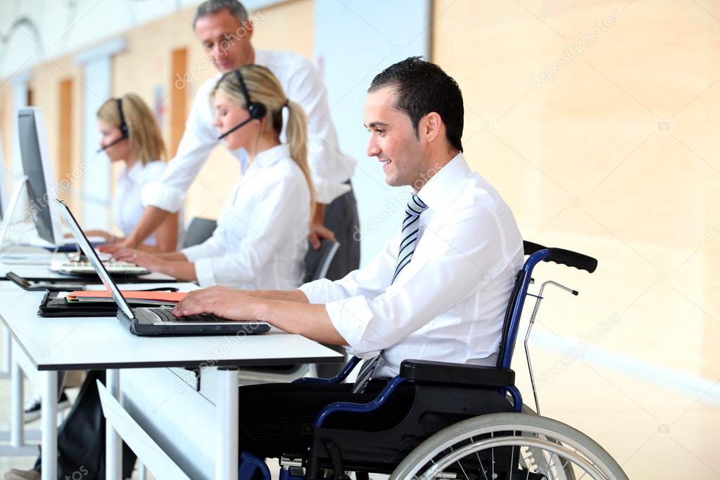 Office worker in wheelchair — Stock Photo © Goodluz #18225395