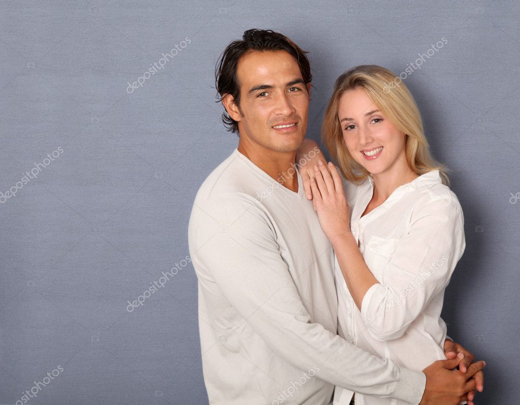 Couple standing on grey background — Stock Photo © Goodluz #18274109