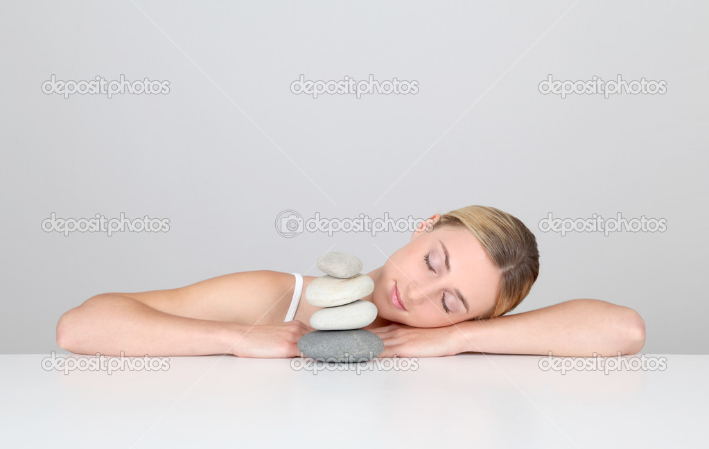 Woman resting with eyes shut by pile of pebbles — Stock Photo © Goodluz ...