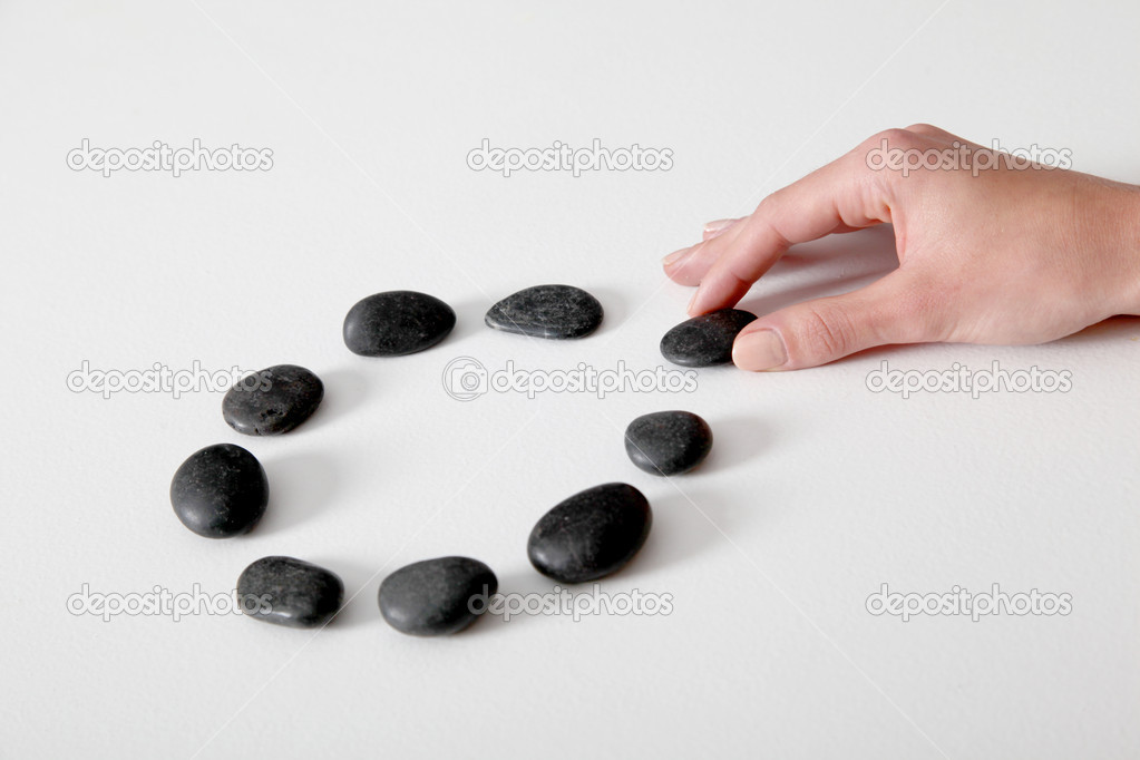 Human hand arranging line of pebbles in circle Stock Photo by ©Goodluz ...