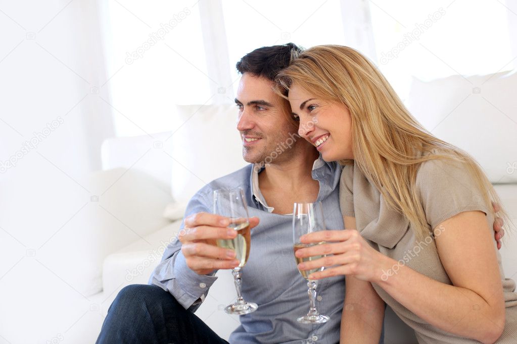 Romantic couple drinking wine at home — Stock Photo © Goodluz #27926209