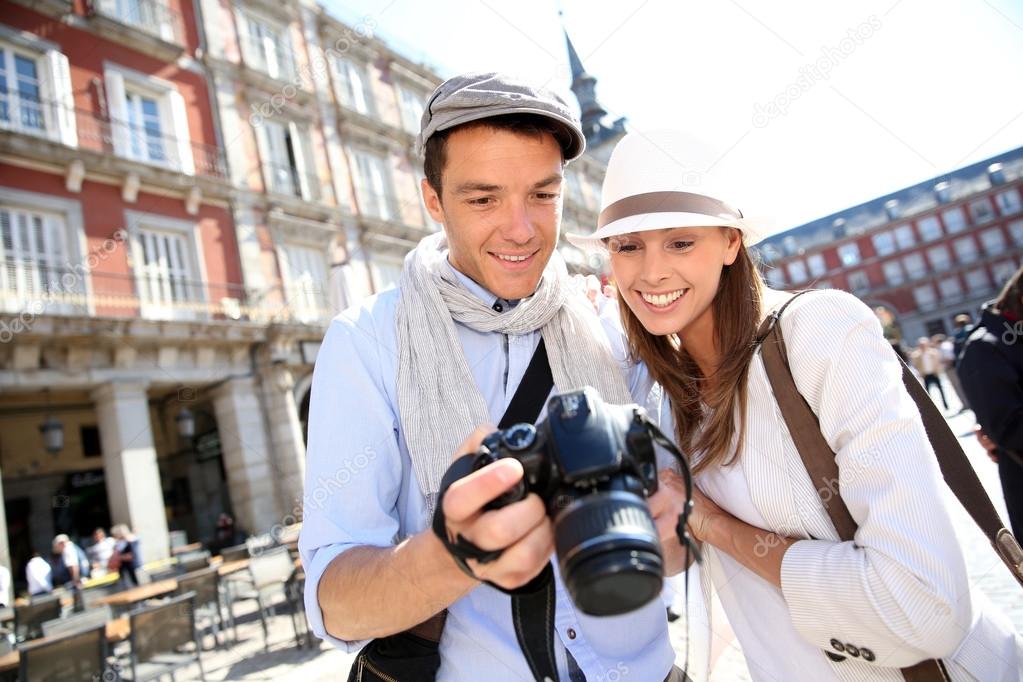 Couple looking at picture shots of Spanish travel journey — Stock Photo ...