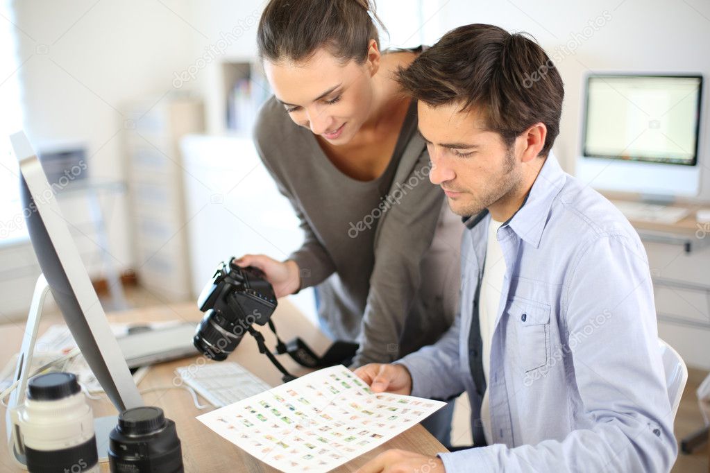 Photo reporters in office — Stock Photo © Goodluz #36646715