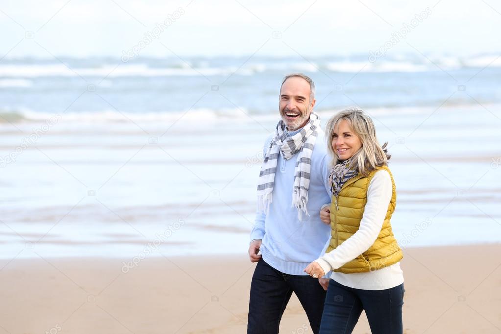 Cheerful couple on beach Stock Photo by ©Goodluz 36648205