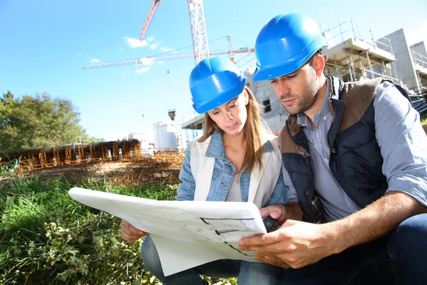 Construction manager and engineer working on building site Stock Photo ...