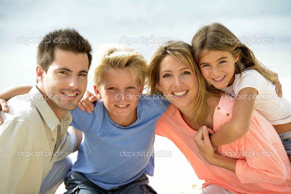 Parents holding kids on their back — Stock Photo © Goodluz #38962907
