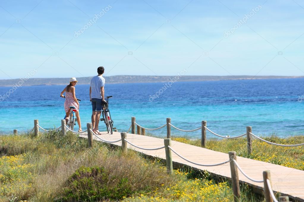 Lovely couple on bikes Stock Photo by ©Goodluz 47791751