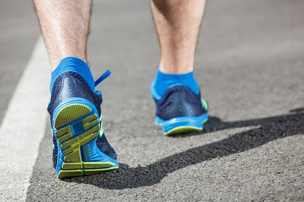 Runner feet running on stadium closeup on shoe. - Stock Image - Everypixel