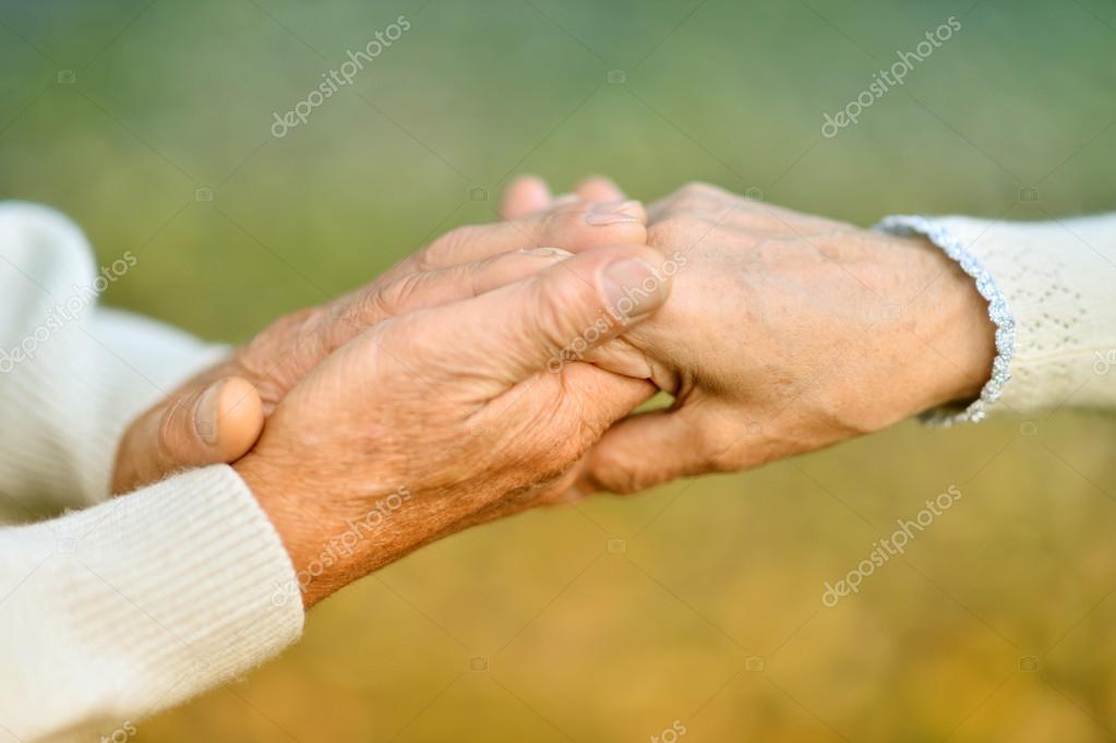 Elderly couple holding hands — Stock Photo © aletia #35247851