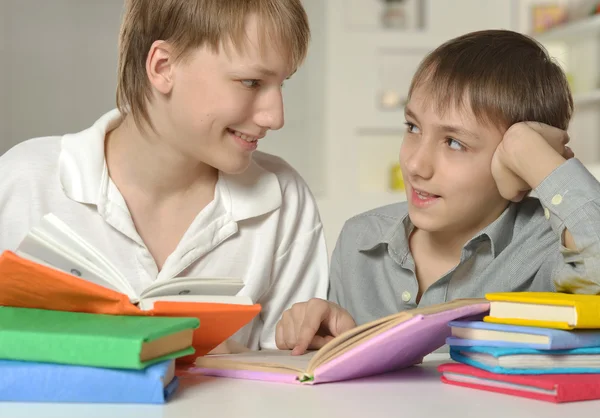 Two brothers doing homework Stock Photo by ©aletia 56806721