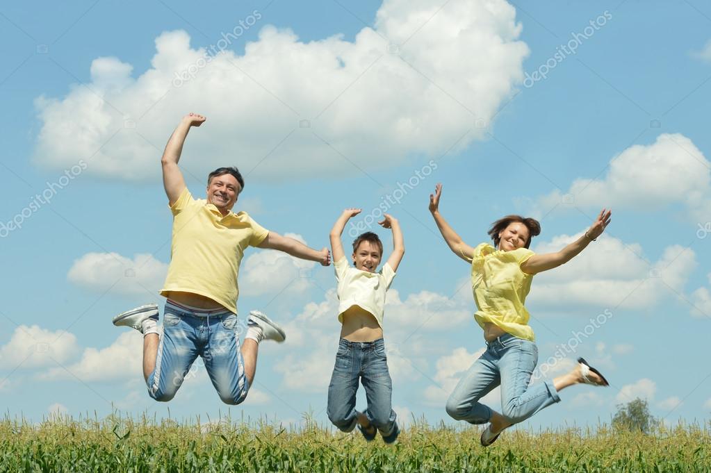 Family jumping on field Stock Photo by ©aletia 50922677