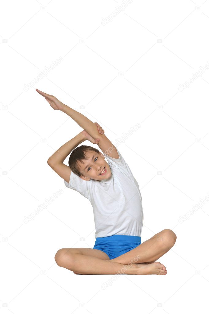 Young boy doing exercises Stock Photo by ©aletia 50923025