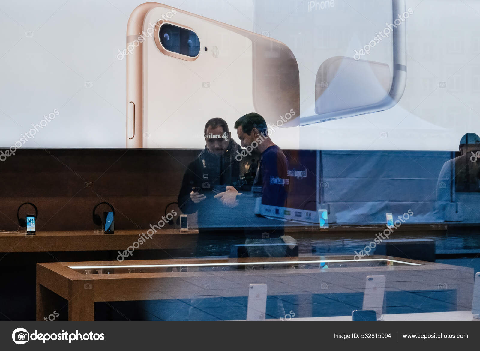 View through the window of customer playing buying new Apple Computers ...