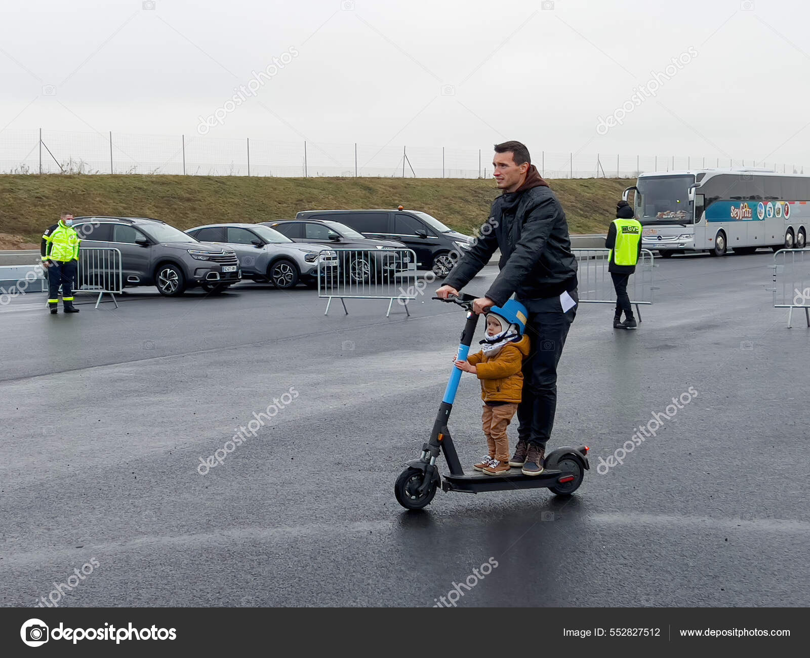 Father and son having fun on a electric scooter during the open days of ...