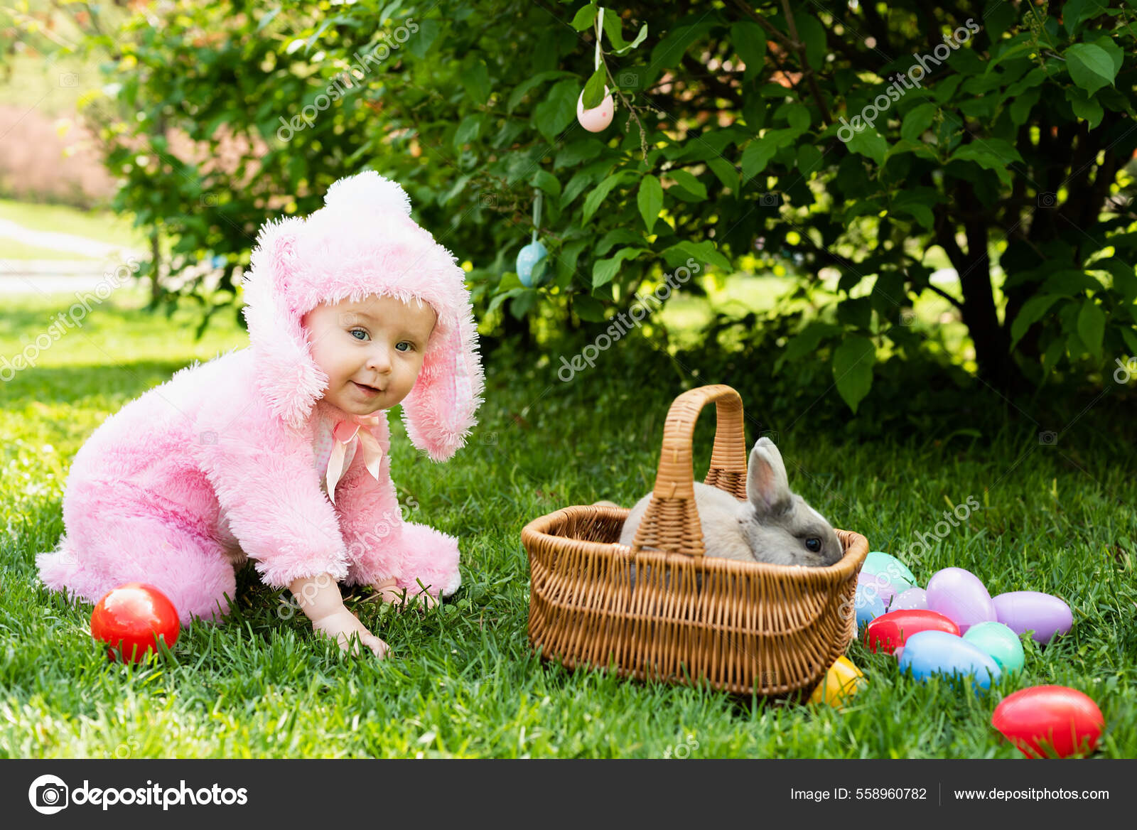 Children play with real rabbit. Laughing child at Easter egg hunt with ...